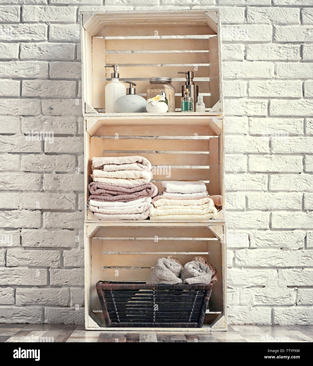 Set for spa procedure in wooden crates on brick wall background Stock ...