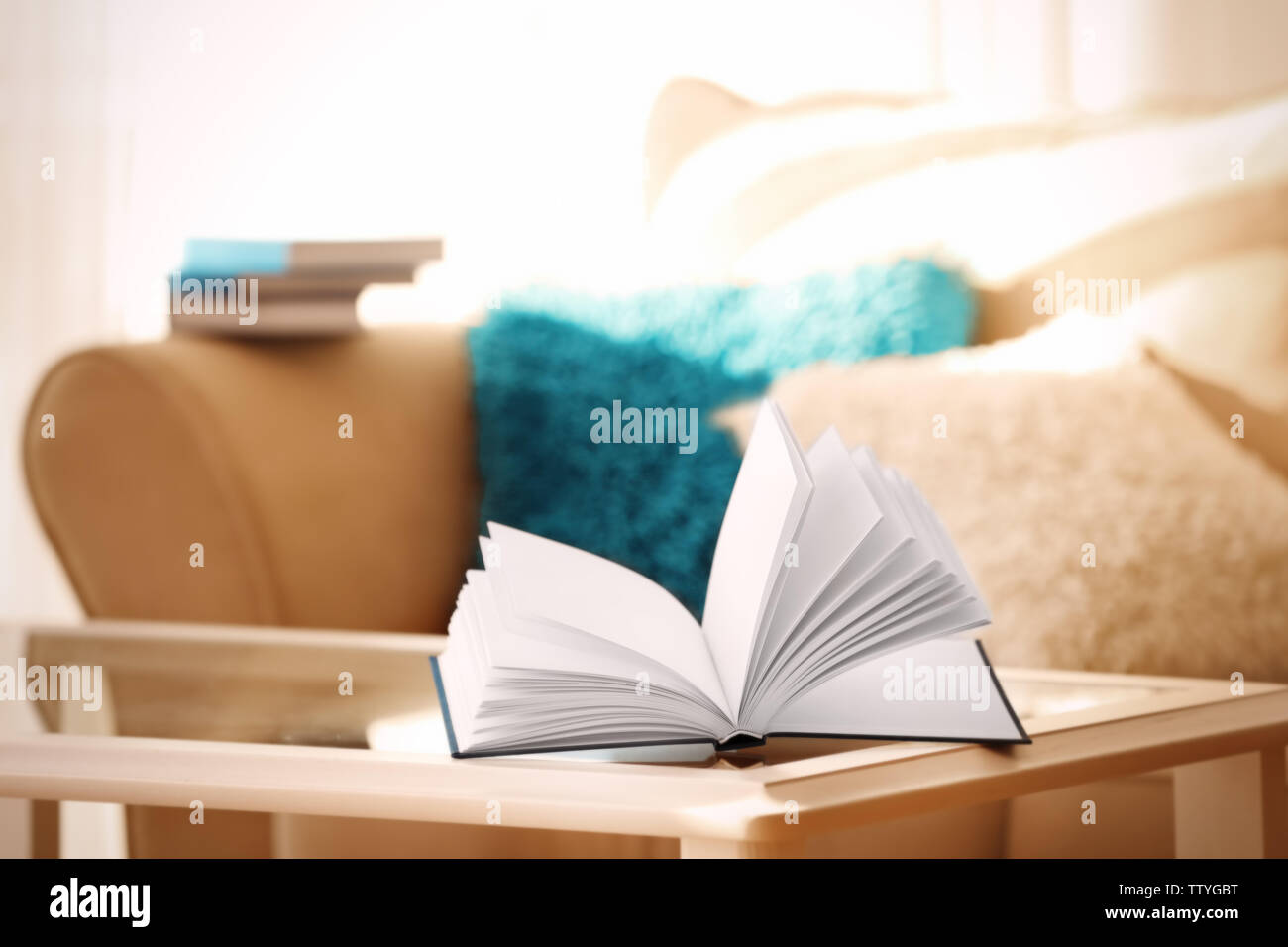 New open book on table in living room Stock Photo - Alamy