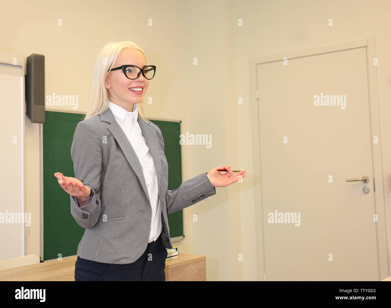 Beautiful school teacher in the classroom Stock Photo - Alamy