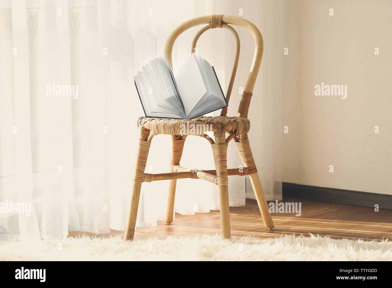 New book on chair, indoors Stock Photo - Alamy