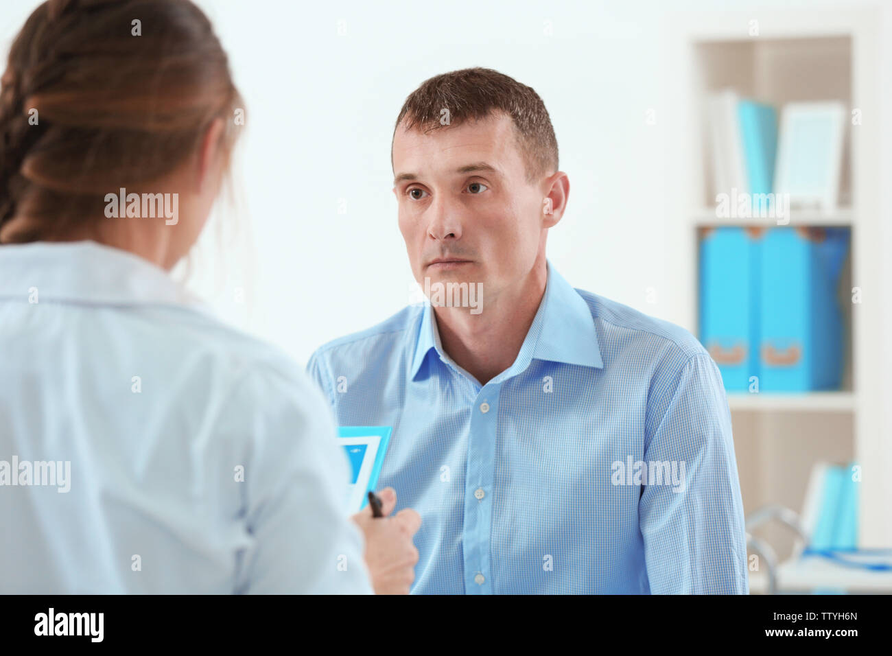 Young man visiting doctor at hospital Stock Photo - Alamy