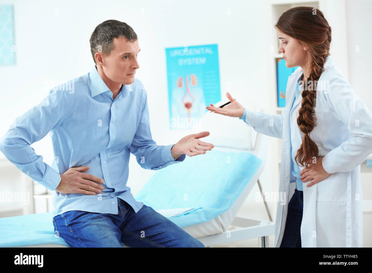 Young man visiting doctor at hospital Stock Photo - Alamy