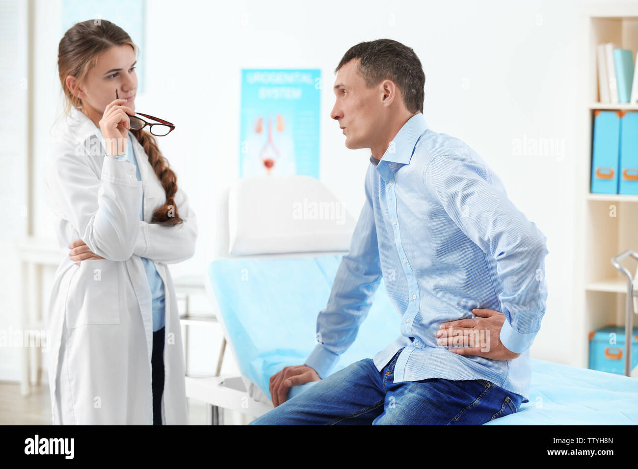Young man visiting doctor at hospital Stock Photo - Alamy