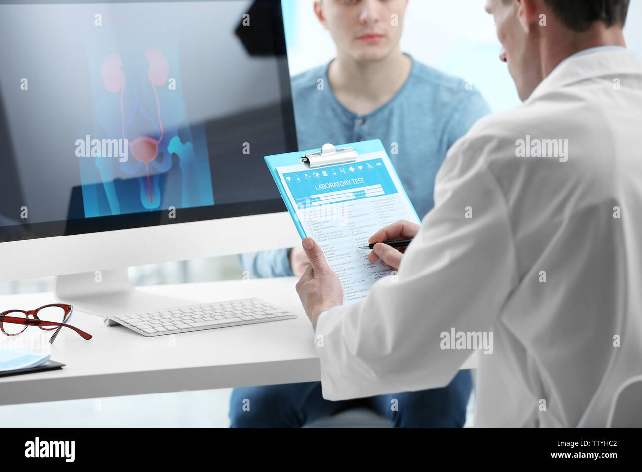 Urology concept. Doctor looking at laboratory test results and talking ...