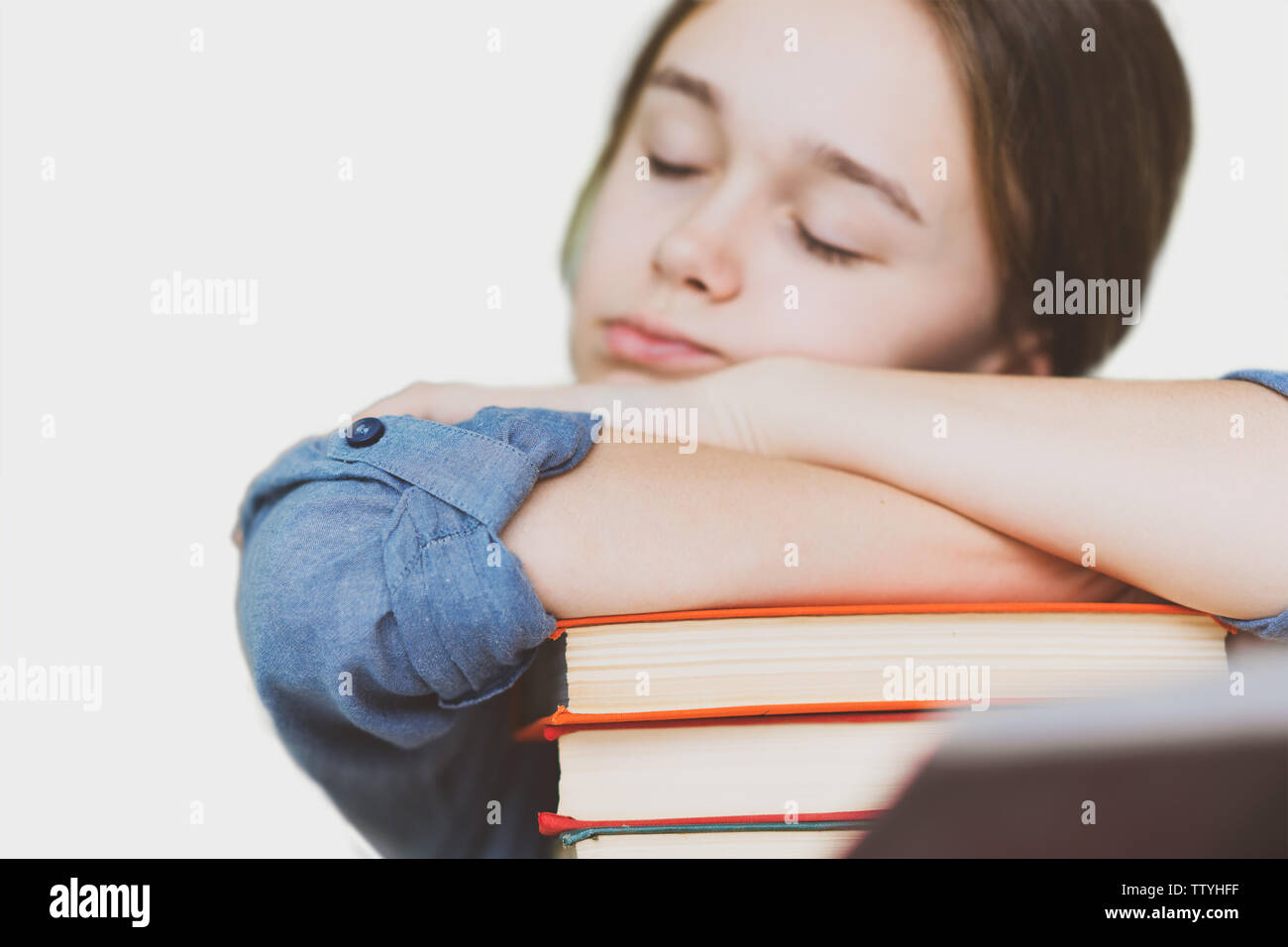 Stressed college student tired of hard learning with books in exams ...