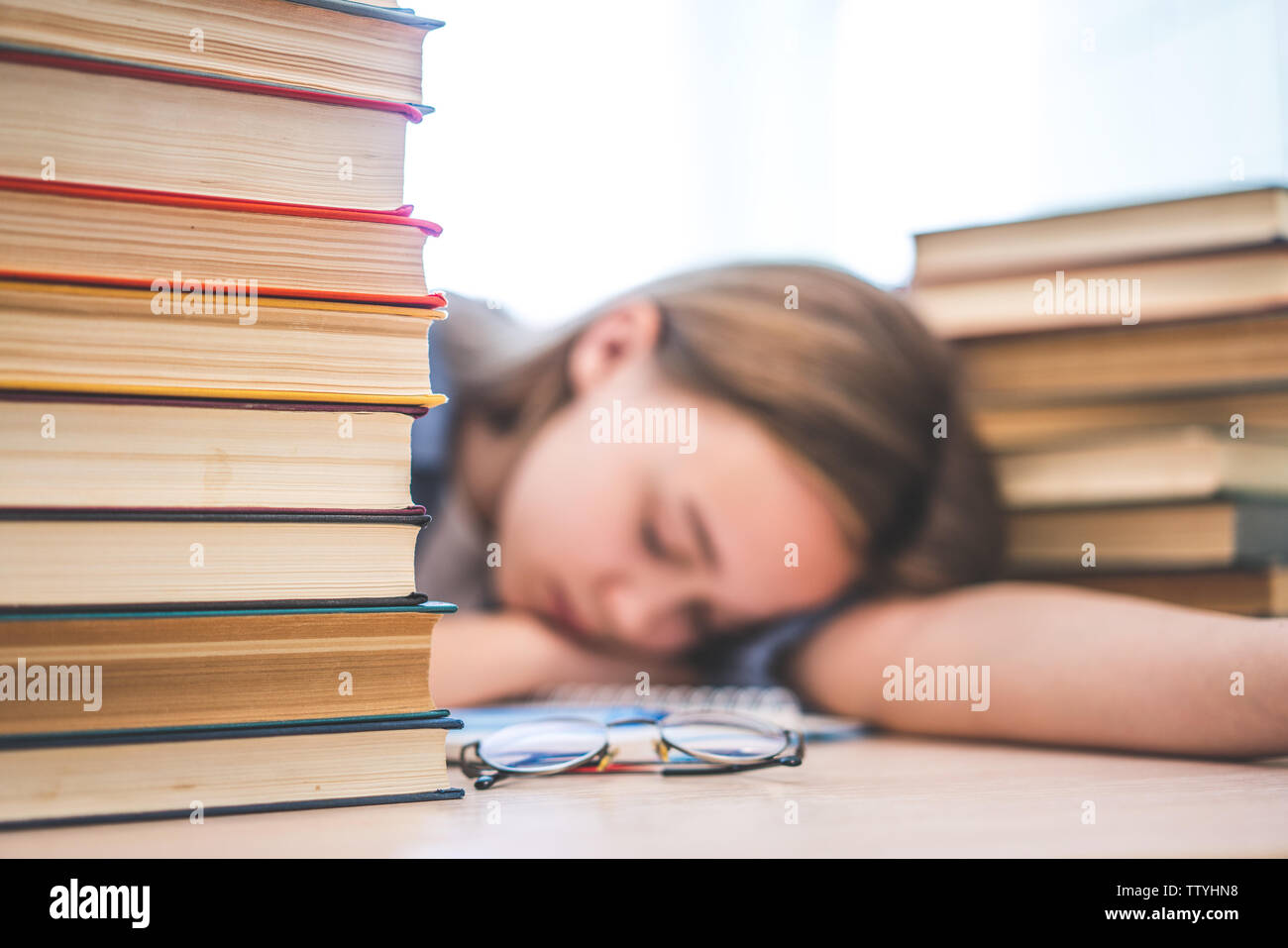 Stressed college student tired of hard learning with books in exams ...