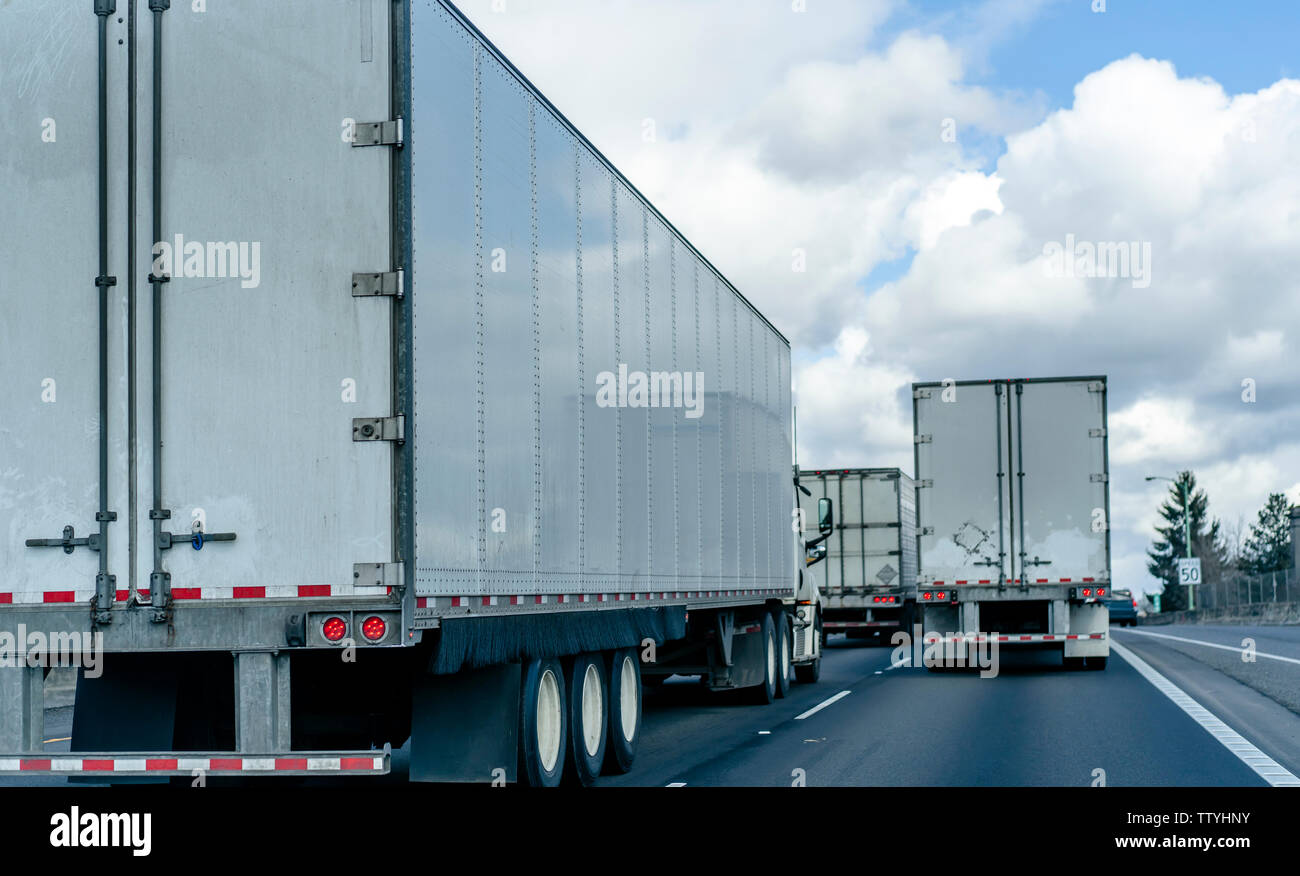 Back view of convoy of the industrial freight transportation of big rig ...