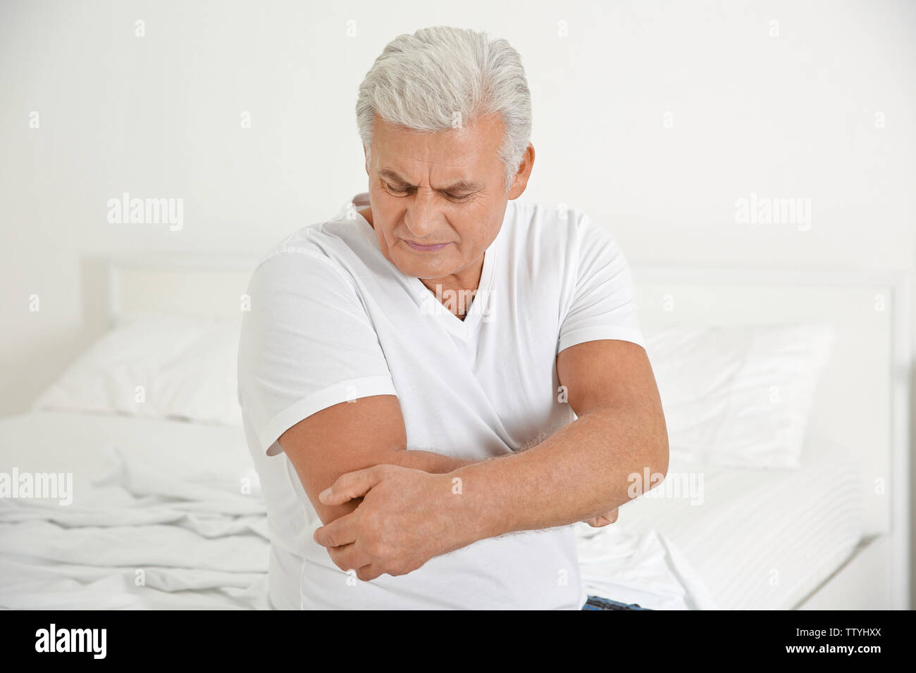 Senior gentleman suffering from pain in bedroom Stock Photo - Alamy