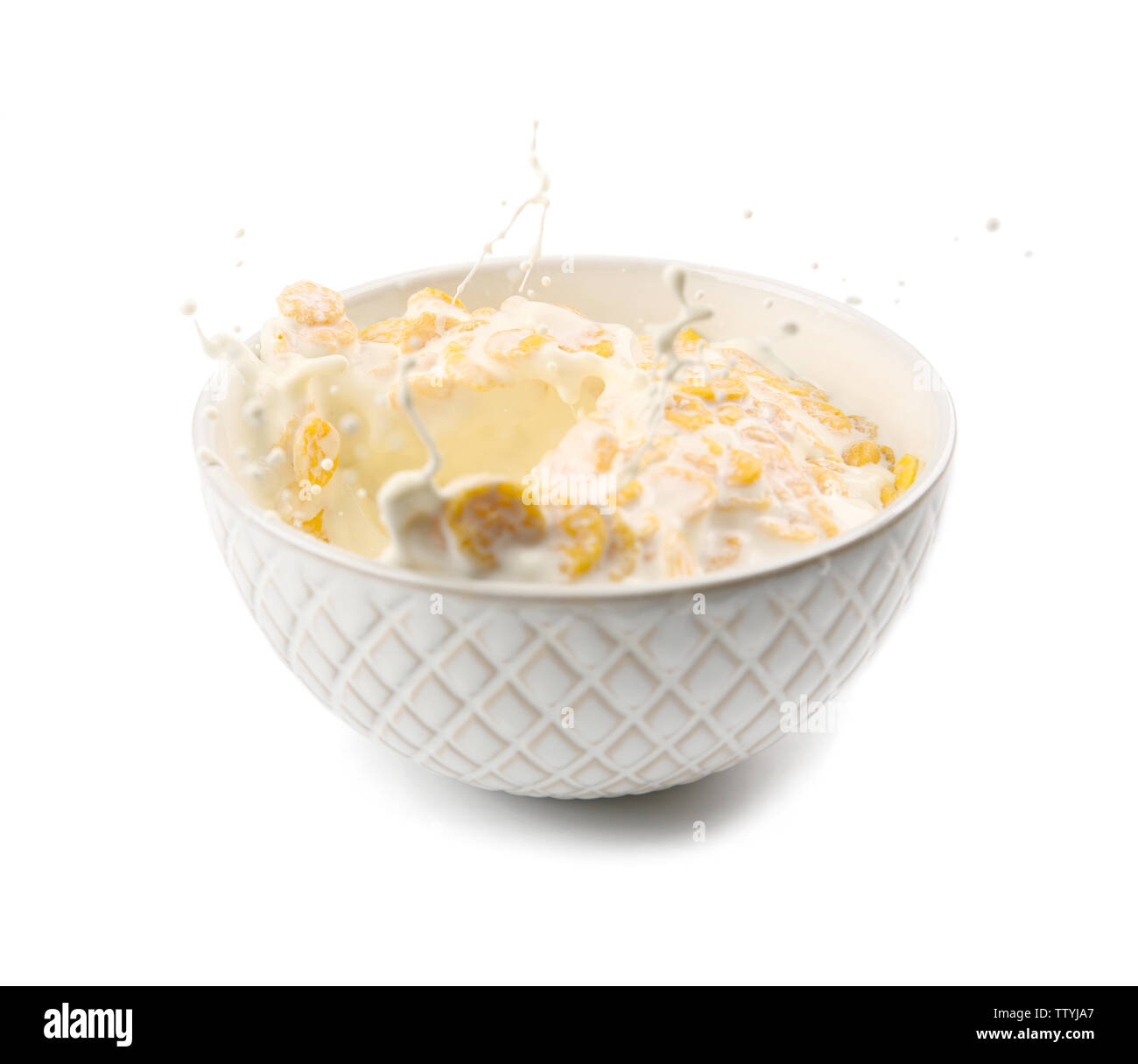 Corn flakes in bowl with milk splash on white background Stock Photo ...