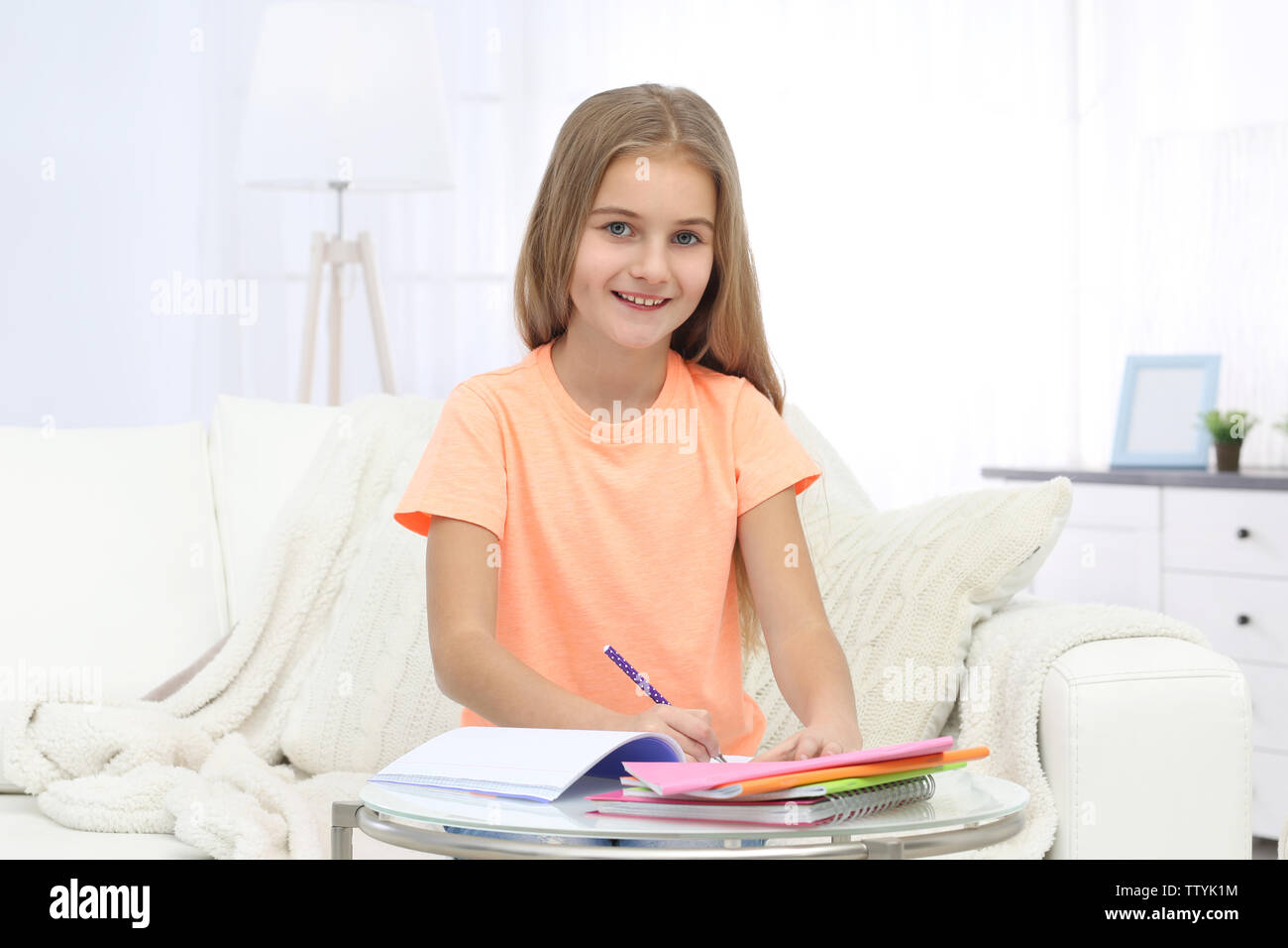 Attractive little girl writing in hi-res stock photography and images ...