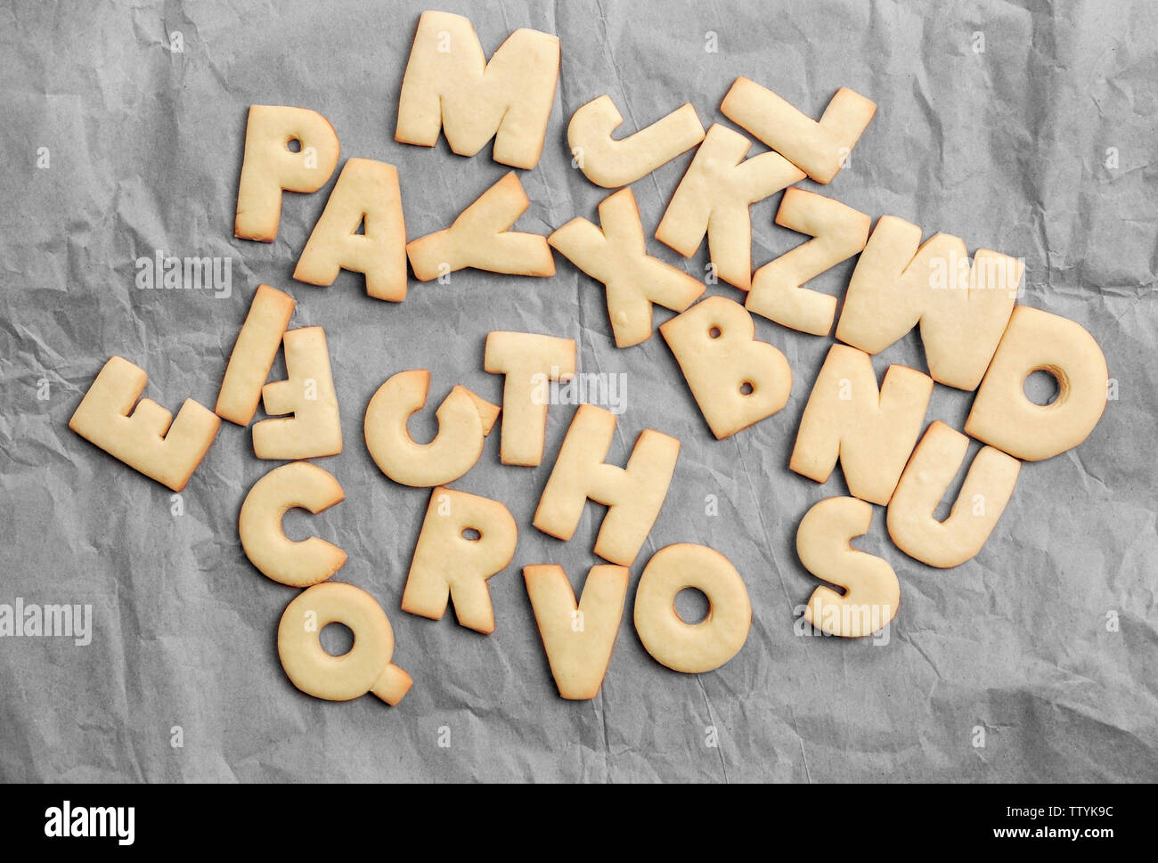 Cookie alphabet on crumpled paper, closeup Stock Photo - Alamy