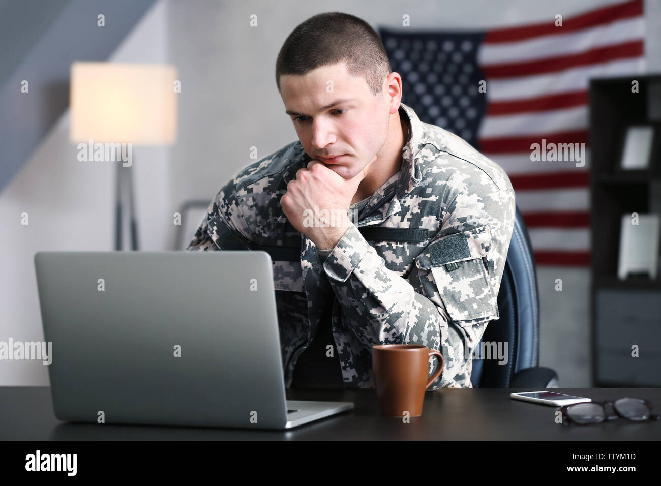Soldier working with laptop in headquarters building Stock Photo - Alamy