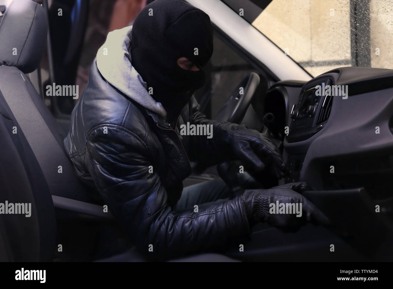 Male thief stealing valuables from car Stock Photo - Alamy