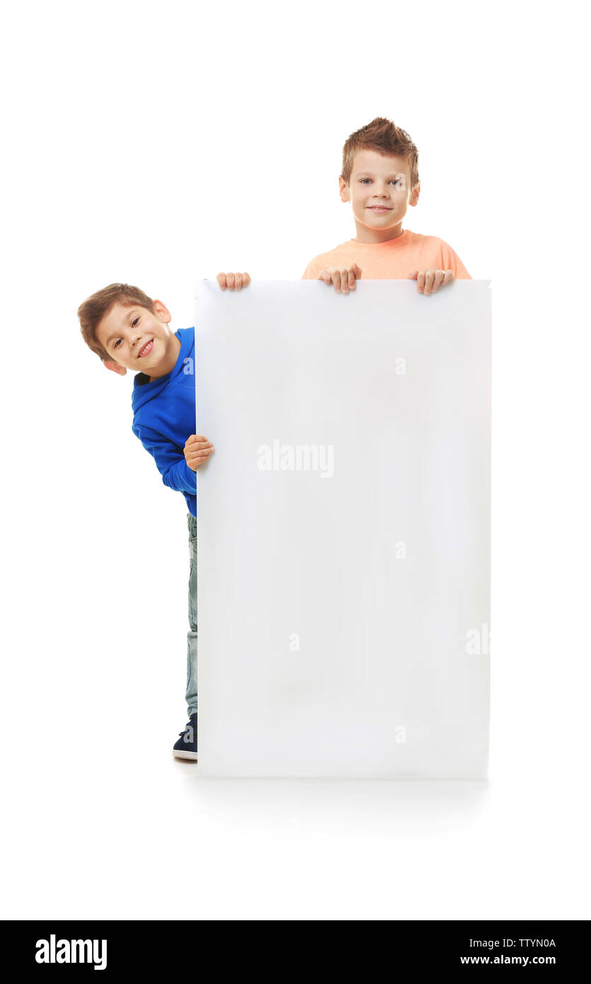 Cute little brothers standing behind board on white background Stock ...