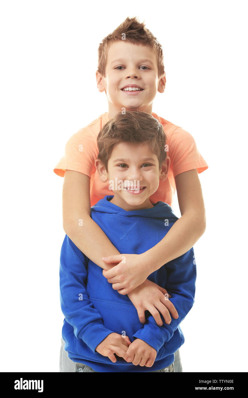 Cute little brothers standing on white background Stock Photo - Alamy