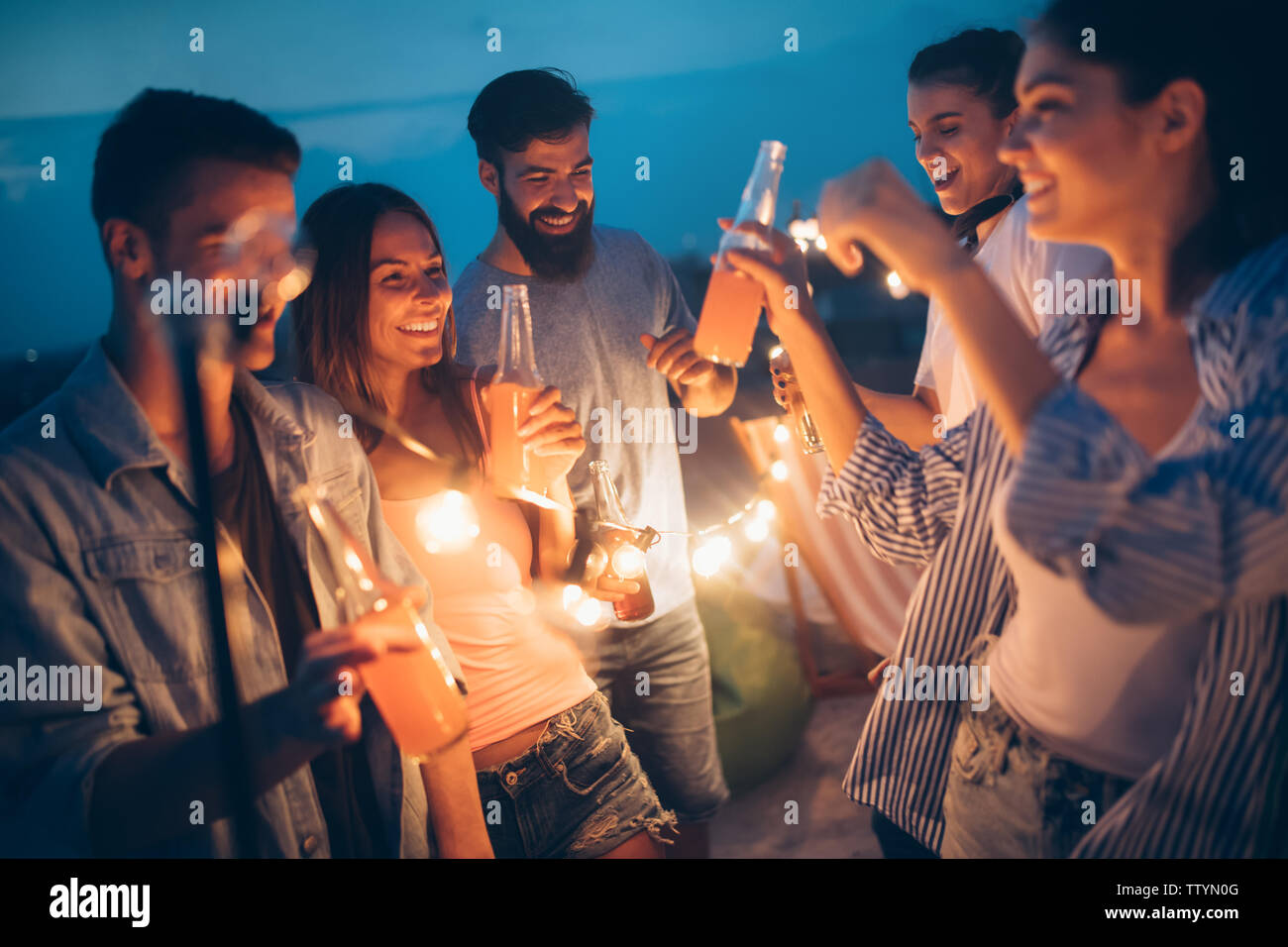 Friends having party on top of the roof. Fun, summer, city lifestyle ...