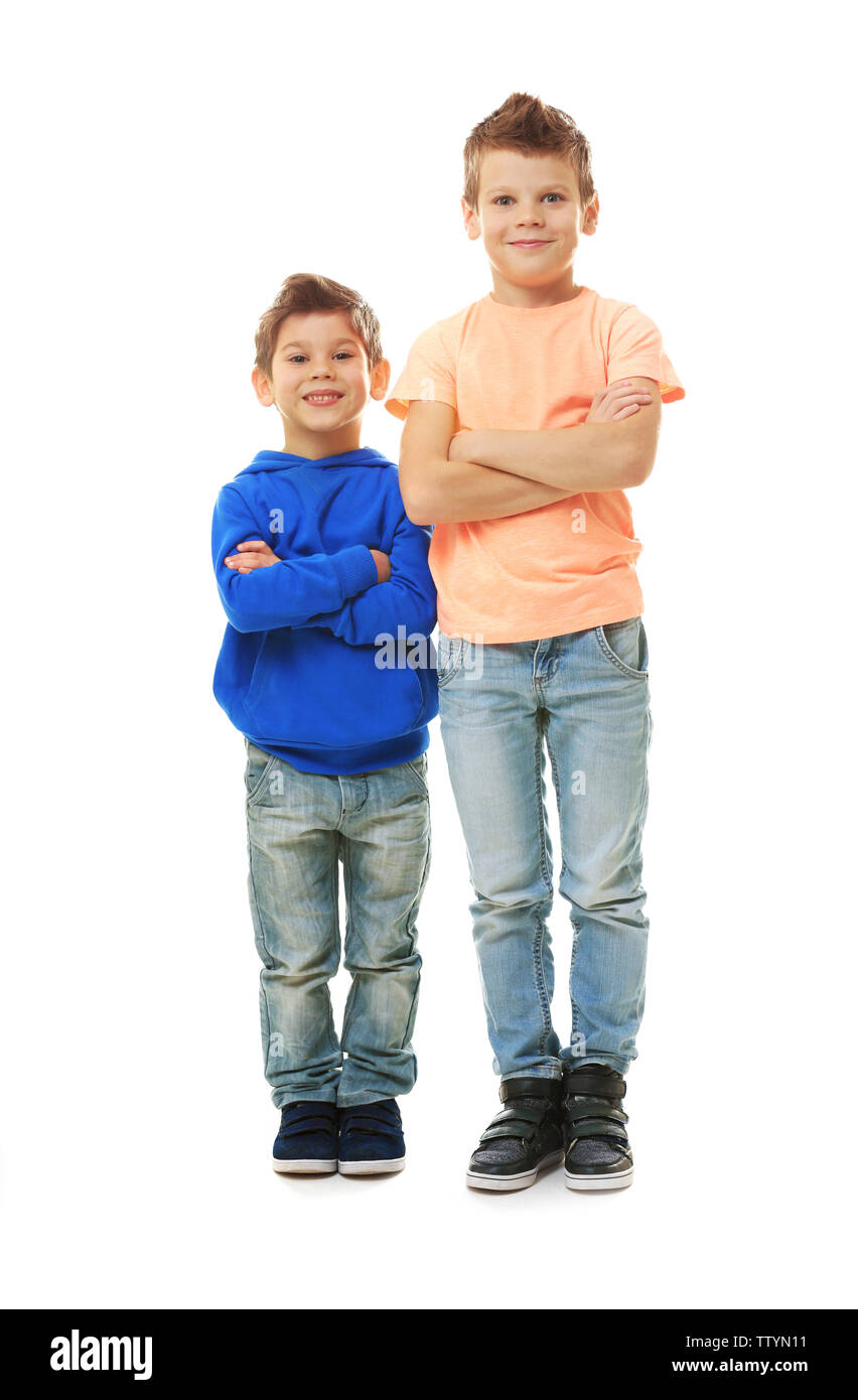 Cute little brothers standing on white background Stock Photo - Alamy