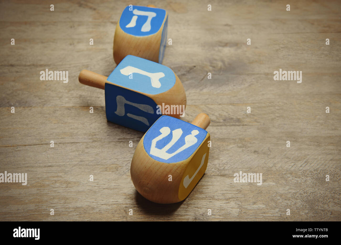 Dreidels for Hanukkah on wooden table, close up Stock Photo - Alamy