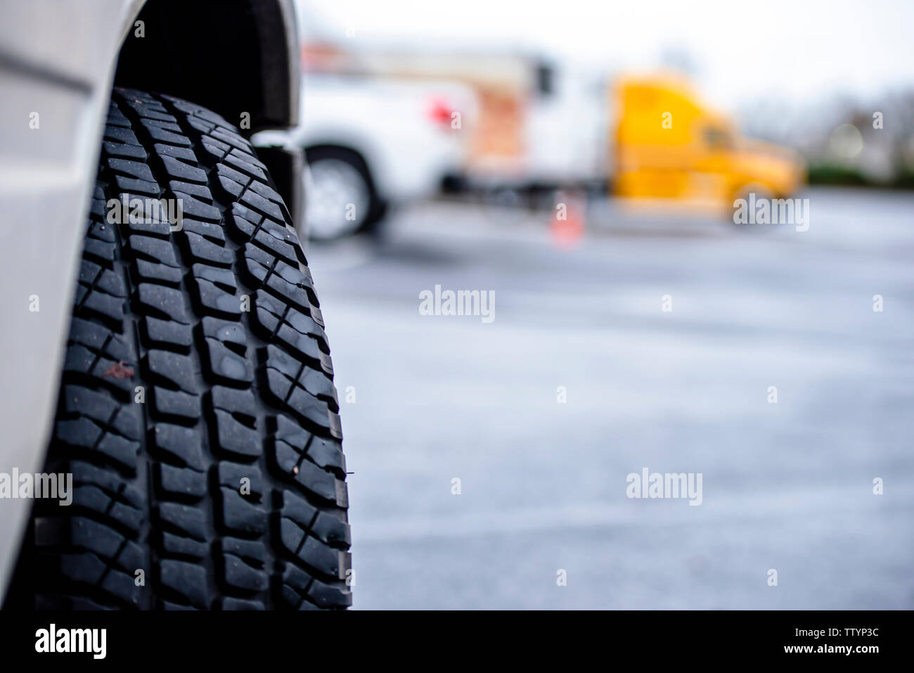 Tire tread of the big rig semi truck wheel on the background of another ...