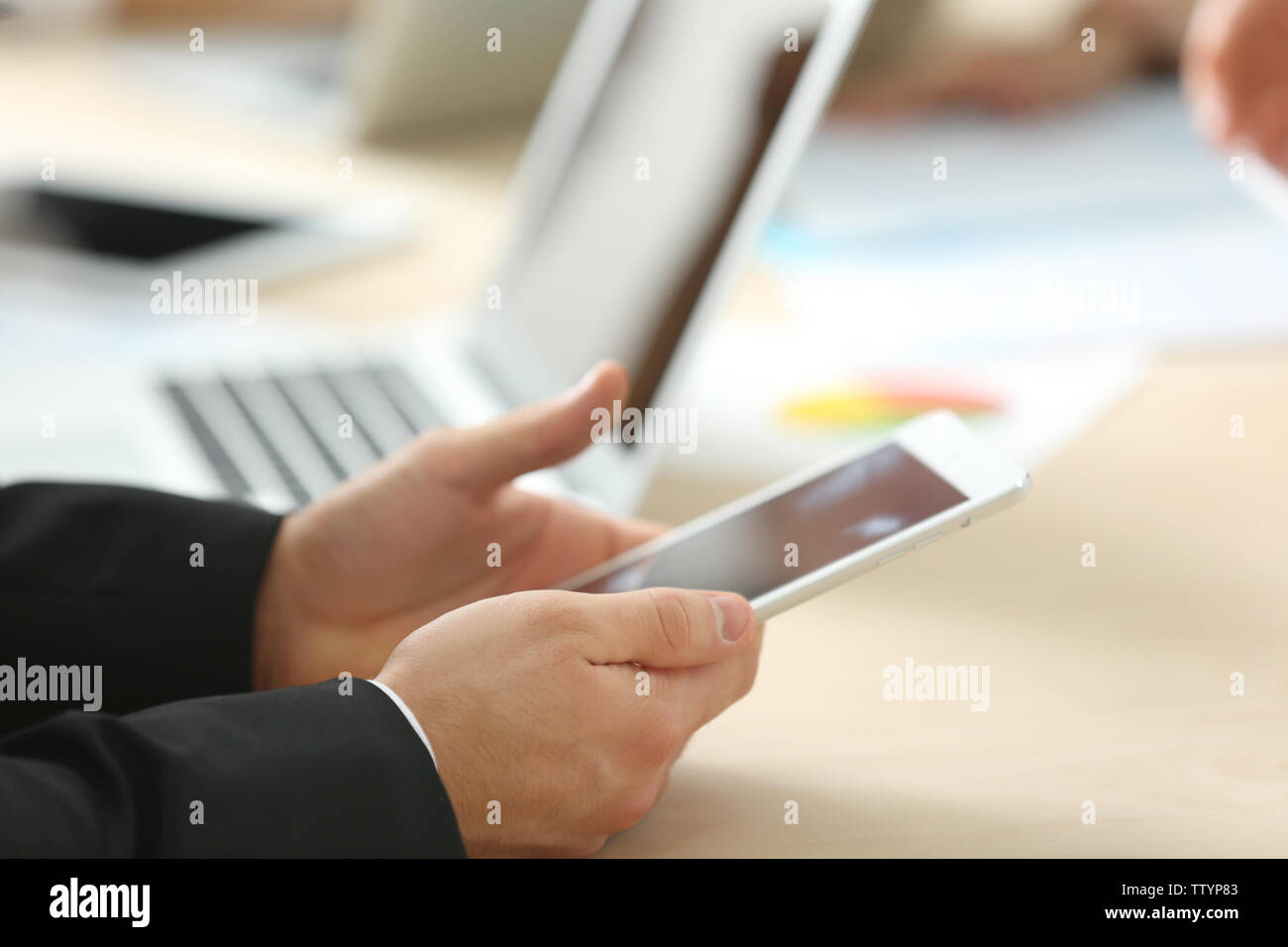 Businessman holding tablet during meeting in office Stock Photo - Alamy