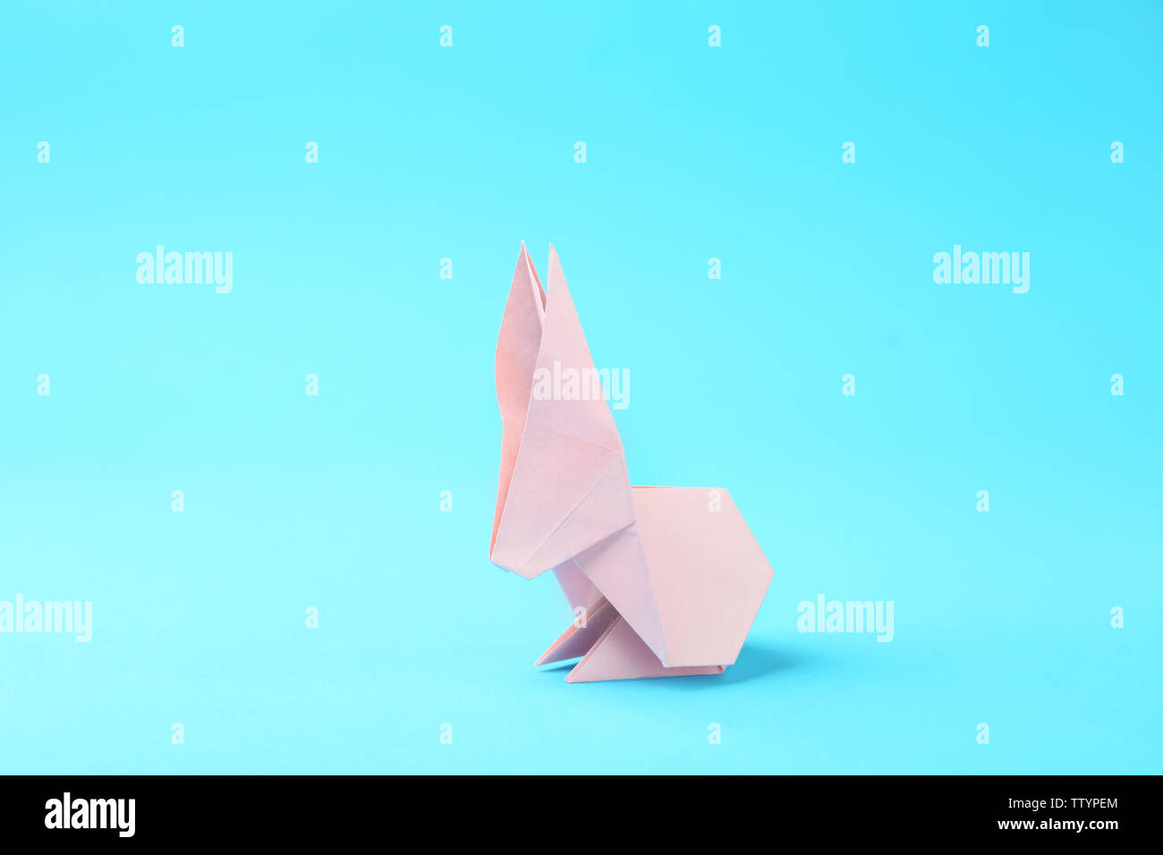 Origami paper bunny on blue background Stock Photo - Alamy