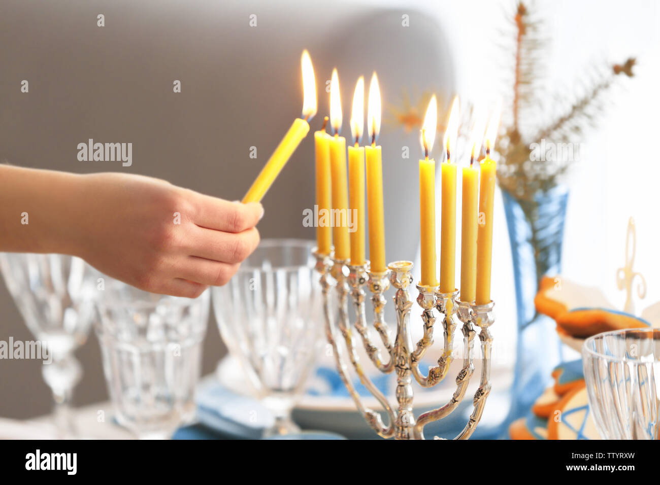 Human hand lighting candles hi-res stock photography and images - Alamy