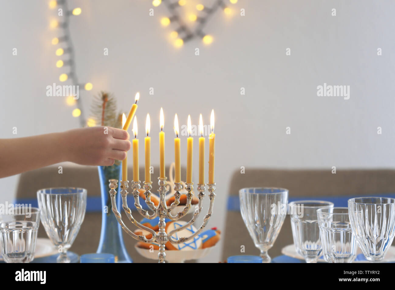 Human hand lighting candles hi-res stock photography and images - Alamy