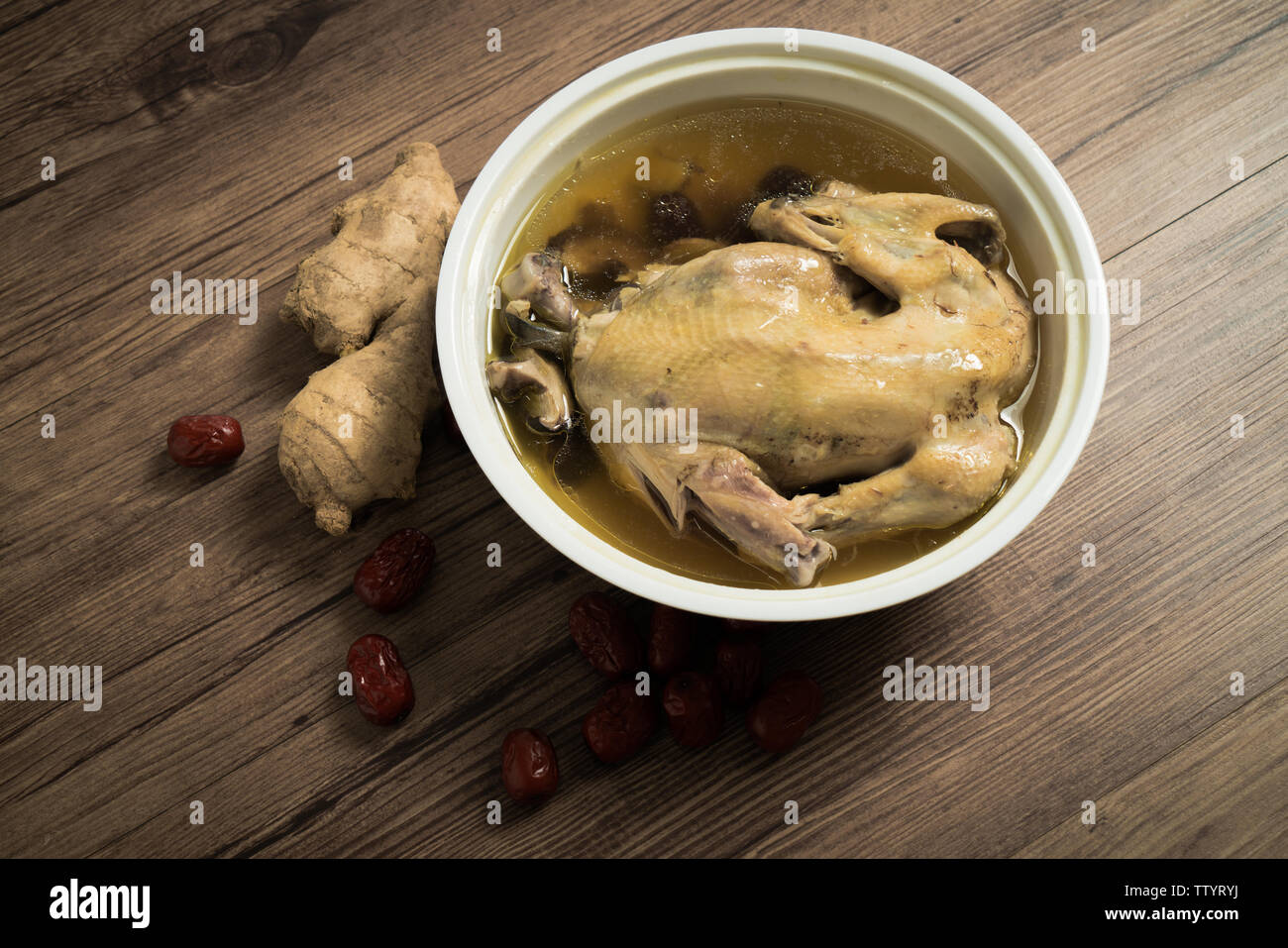 Chicken soup with wood pattern background Stock Photo - Alamy