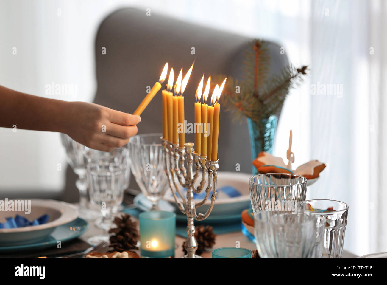 Human hand lighting candles hi-res stock photography and images - Alamy