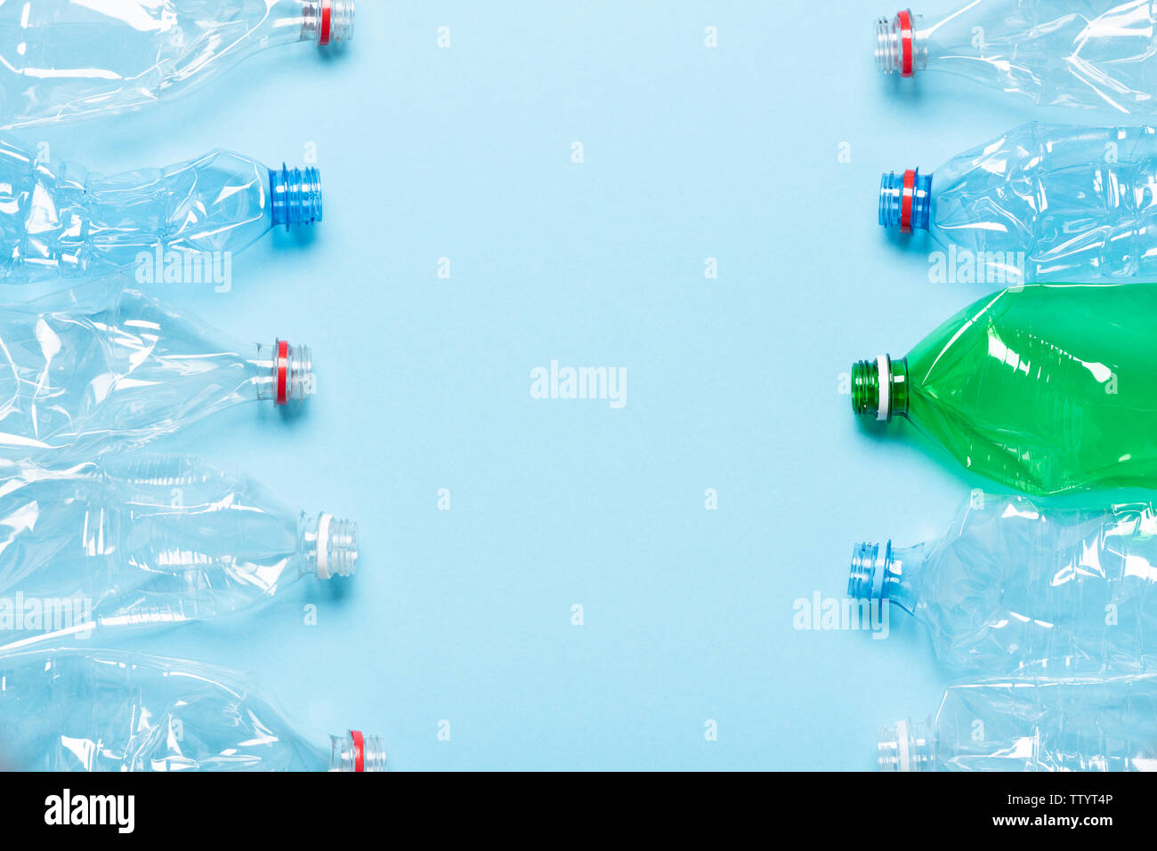 Single use plastic bottles on blue background with copy space top view ...