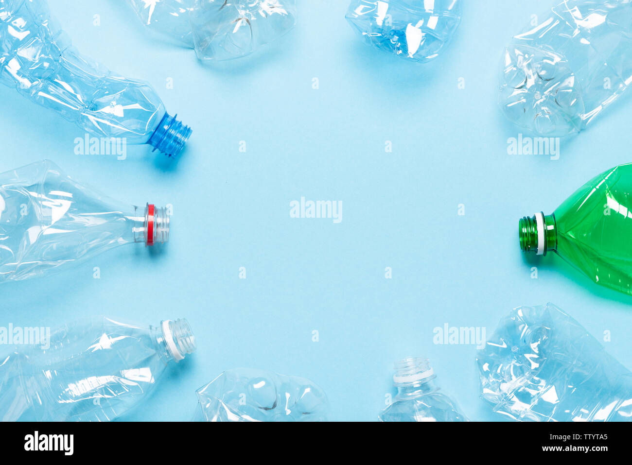 Single use plastic bottles on blue background with copy space top view ...
