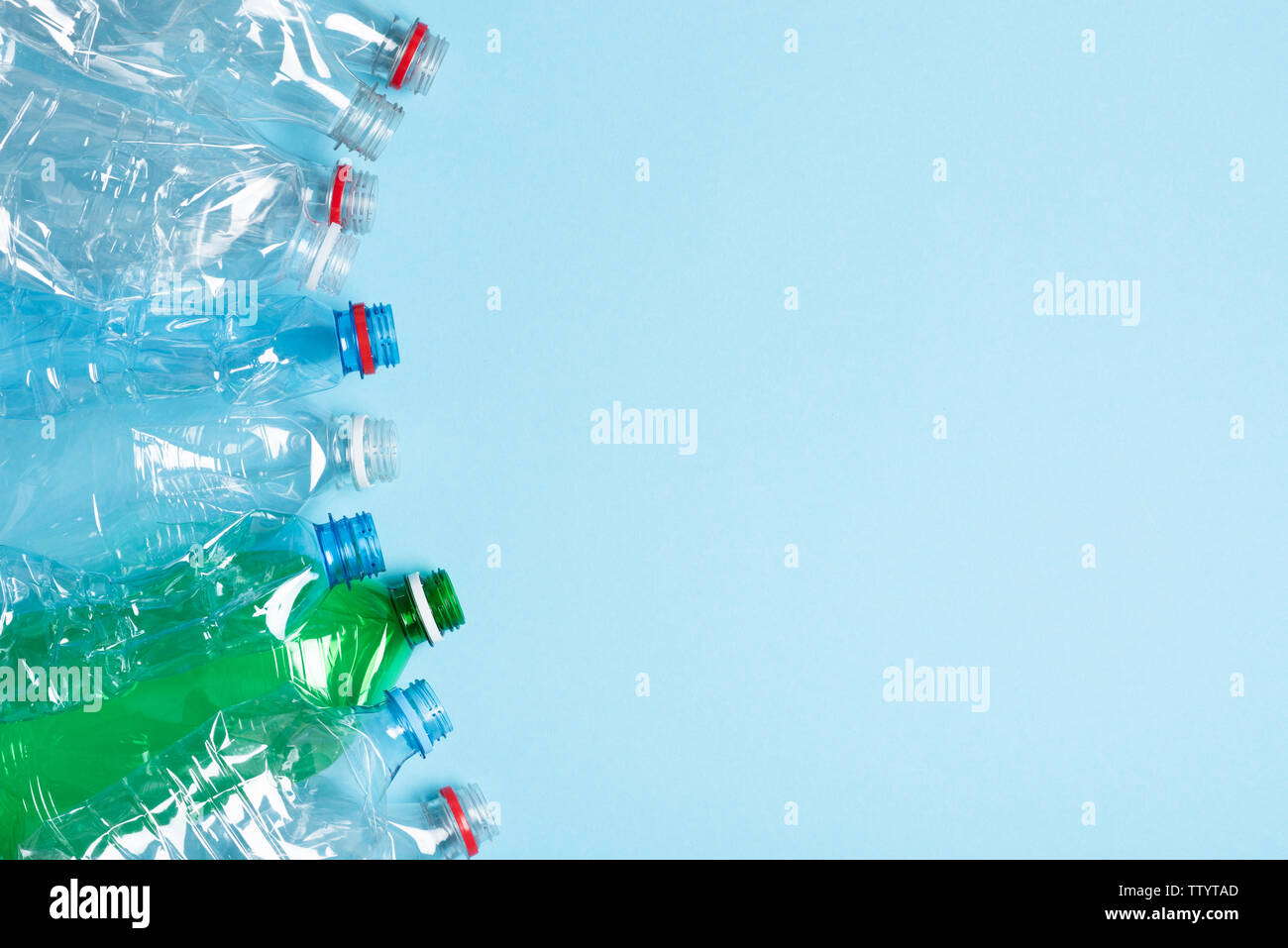 Single use plastic bottles on blue background. Recycling concept with ...