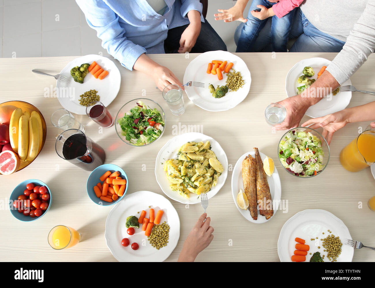 Family having lunch in kitchen Stock Photo - Alamy