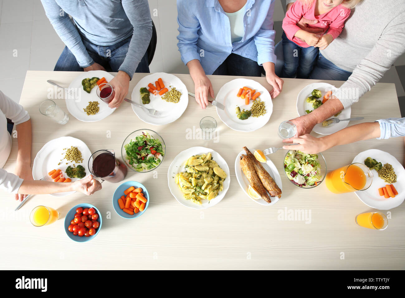 Family having lunch in kitchen Stock Photo - Alamy