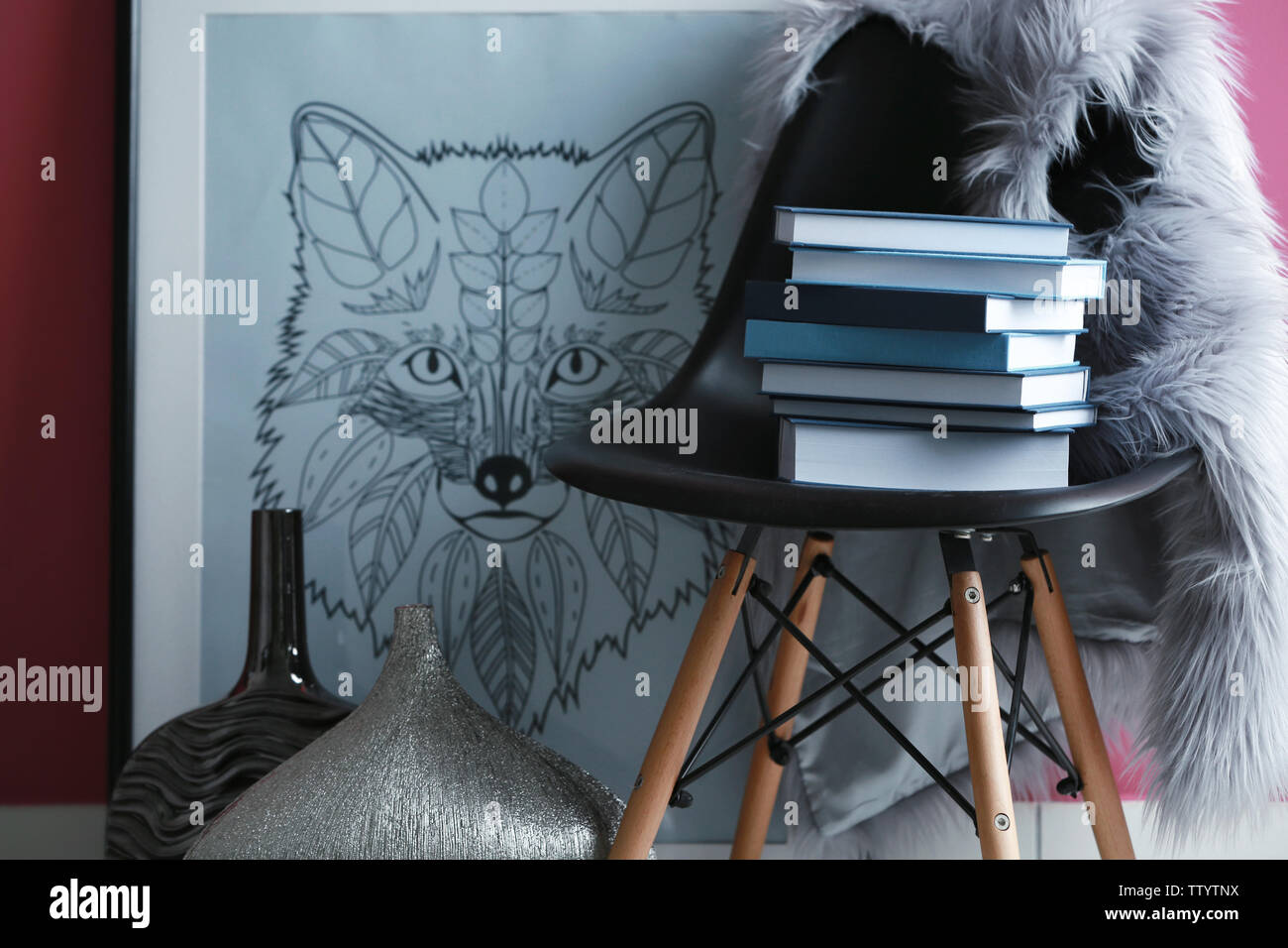 Design interior with stack of books on chair Stock Photo - Alamy