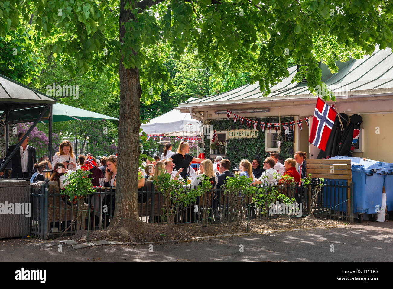 Oslo, view in late spring of Norwegian people relaxing at tables at a ...