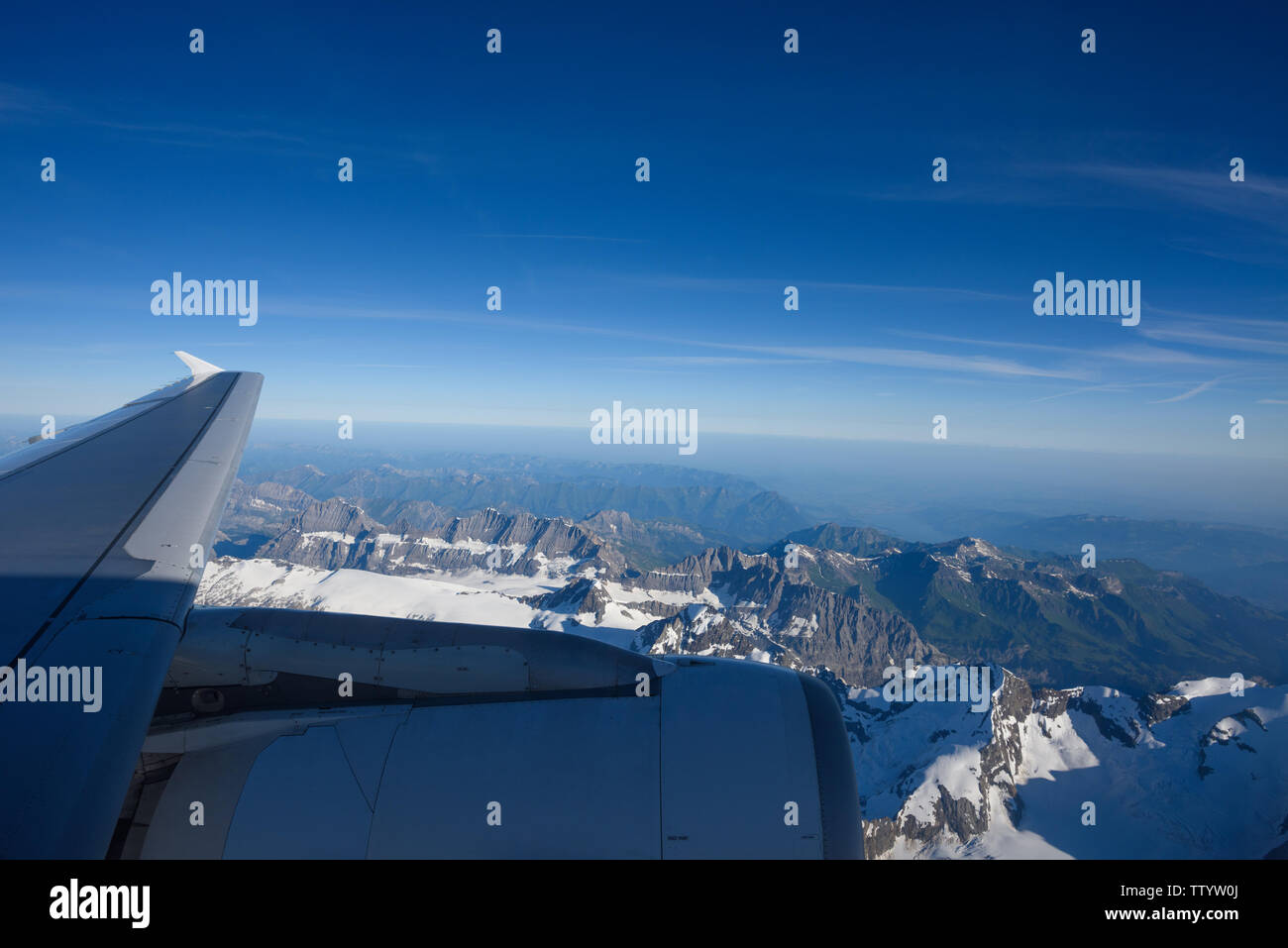 Mountain range from airplane window Stock Photo - Alamy