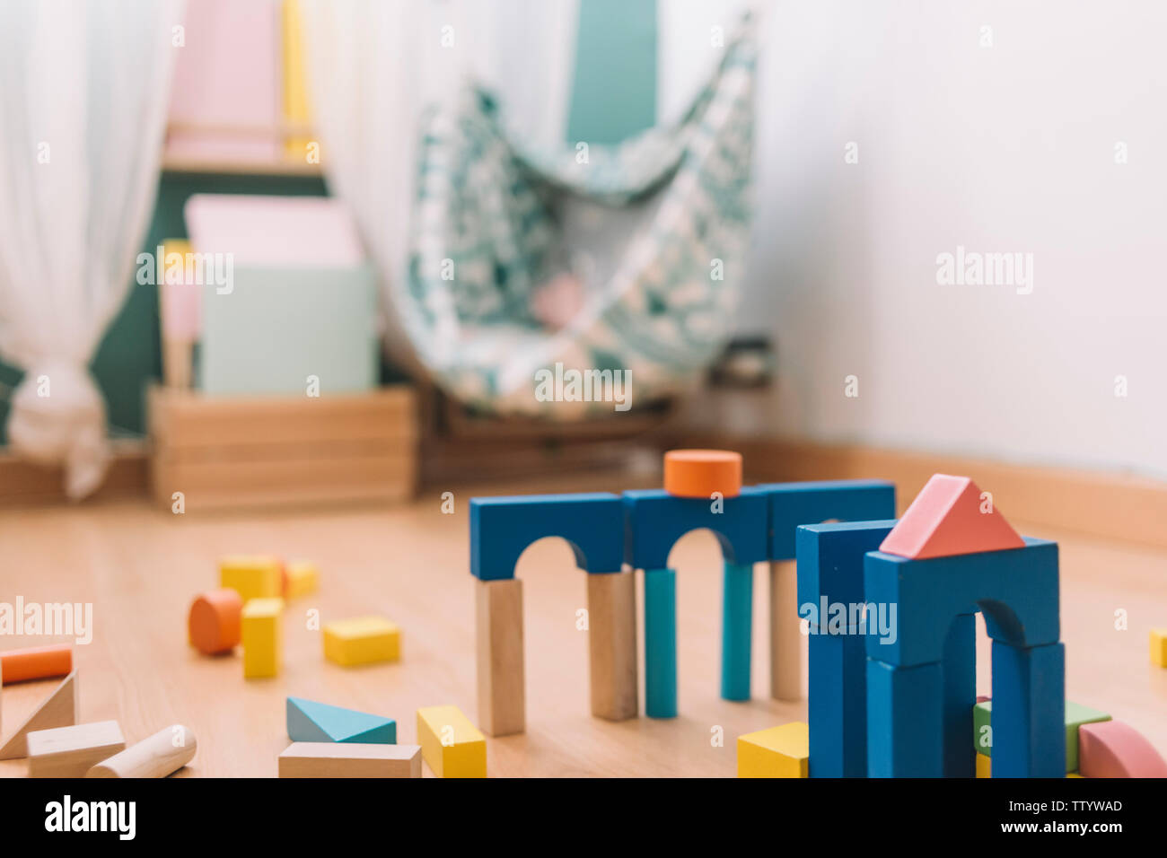 colorful wooden building blocks in the floor at home or kindergarten ...