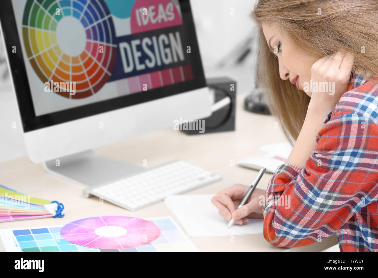 Beautiful young designer working in office Stock Photo - Alamy
