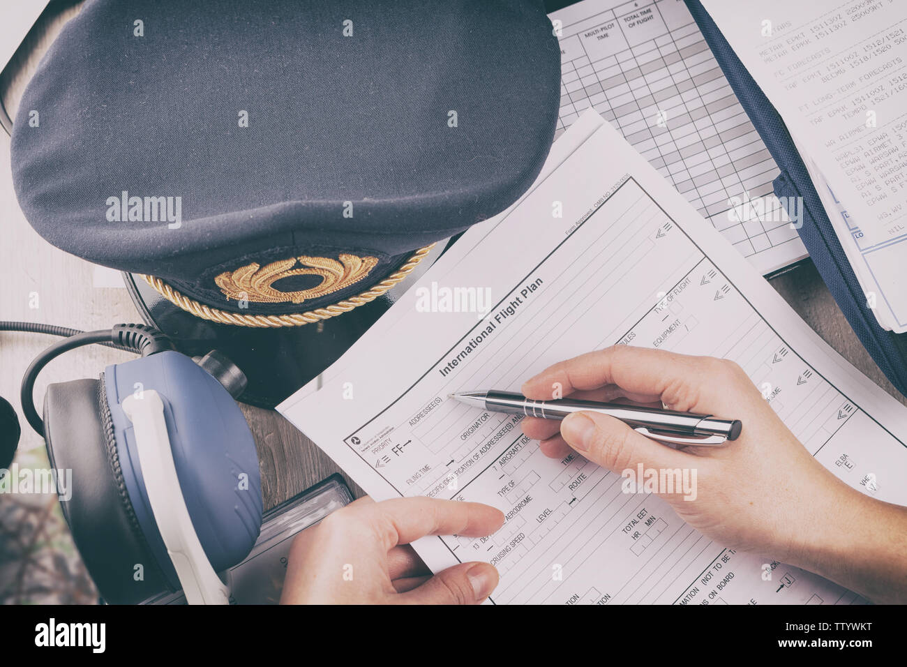 Close up of an airplane pilot hand filling in an pre-fligh checklist ...