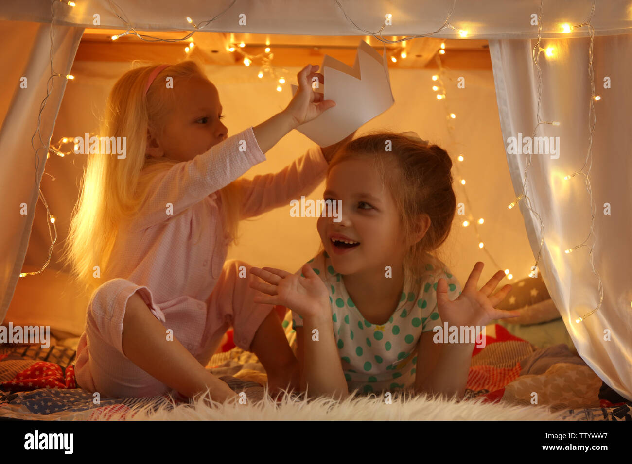 Cute little girls playing in hovel at home Stock Photo - Alamy