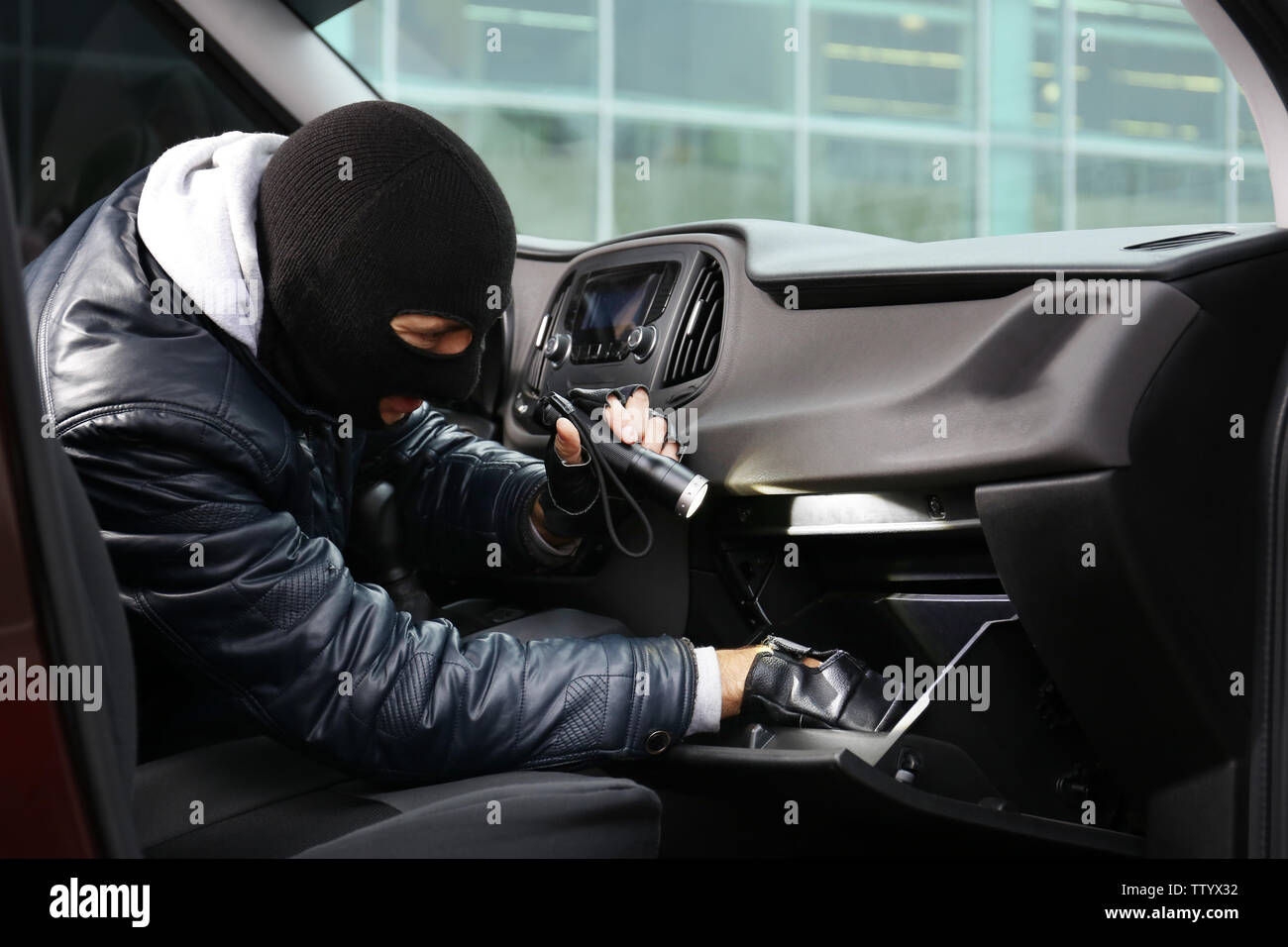Male thief stealing valuables from car Stock Photo - Alamy