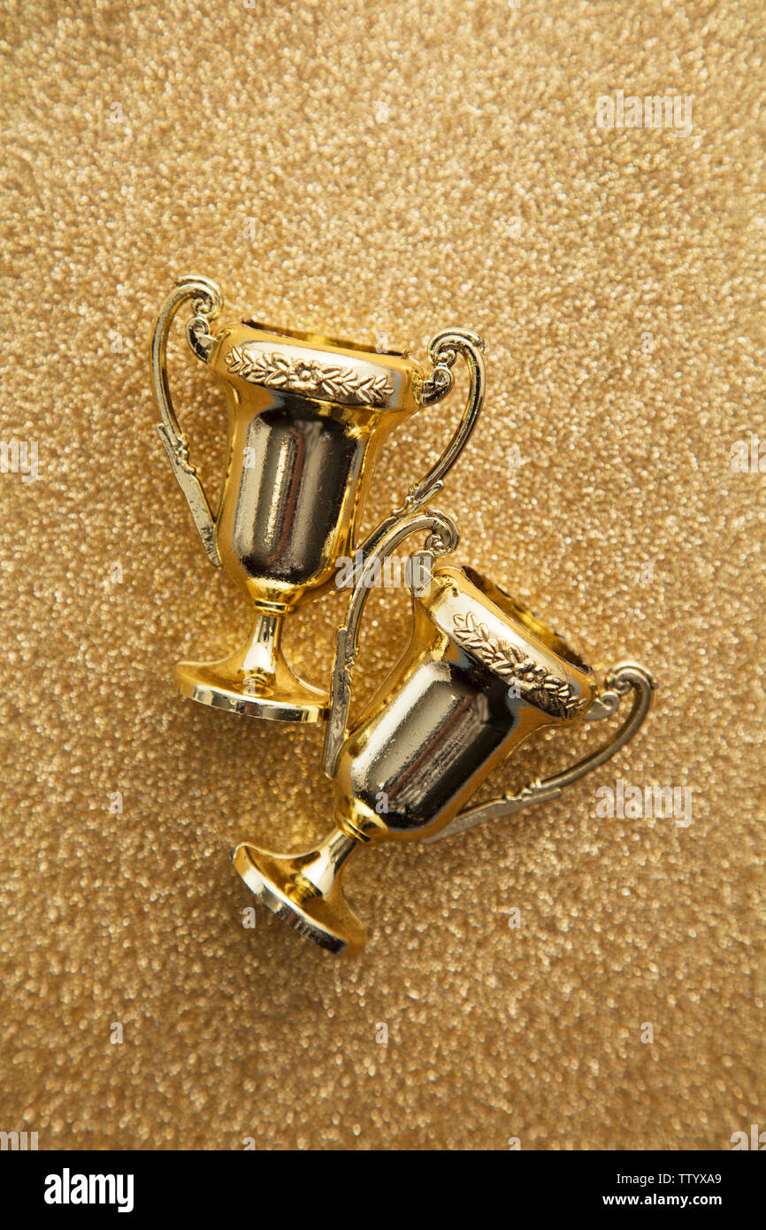 Gold winners achievement trophy on a gold glitter background Stock ...