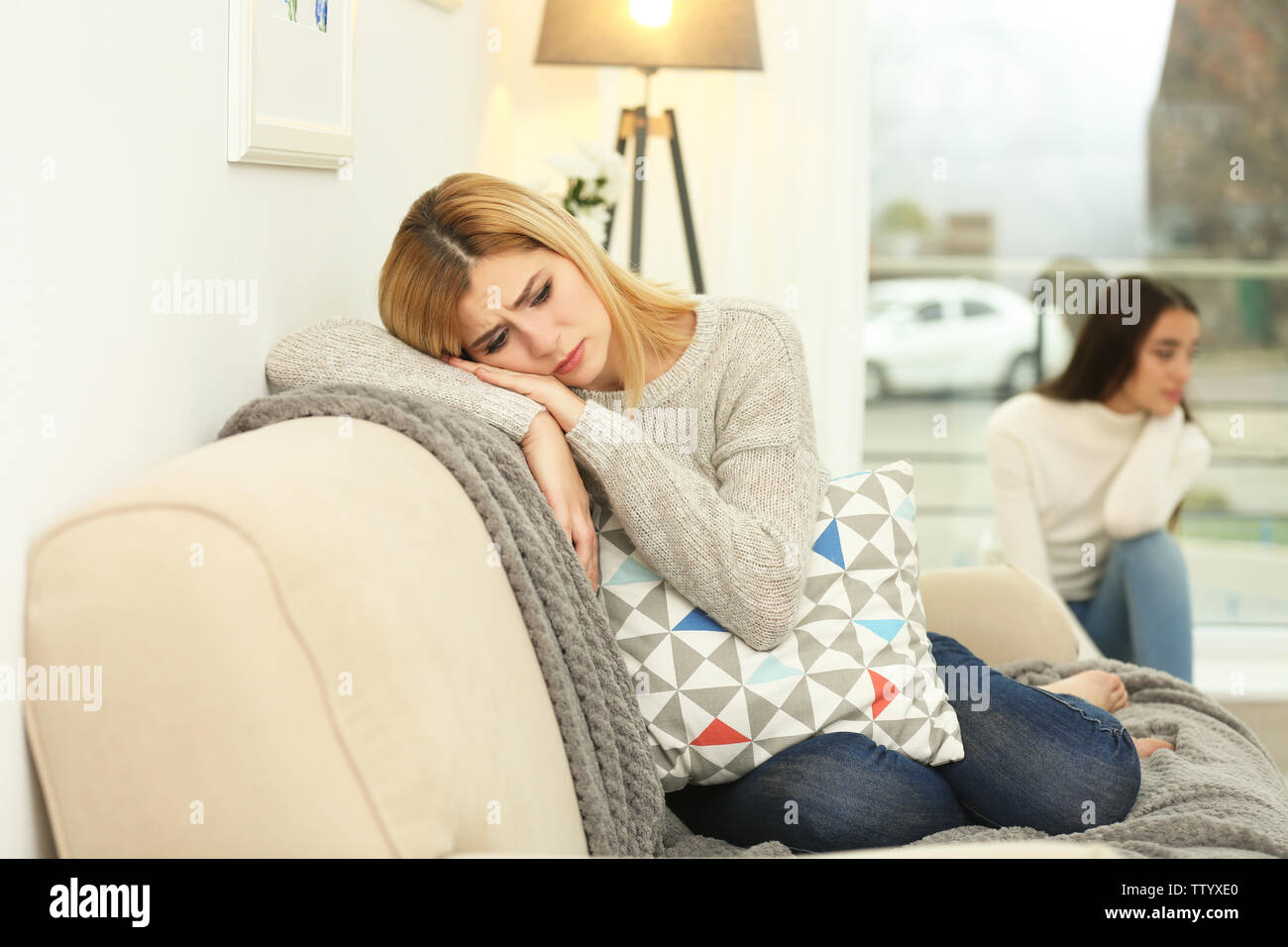 Two quarrelled women in bad mood at home Stock Photo - Alamy