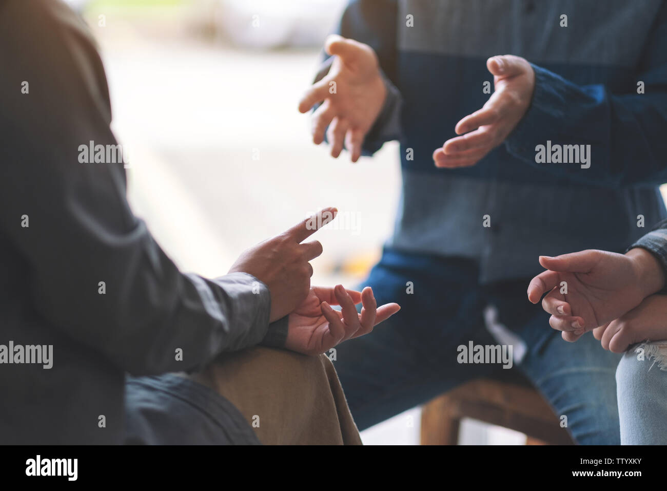 People sitting and talking together Stock Photo - Alamy