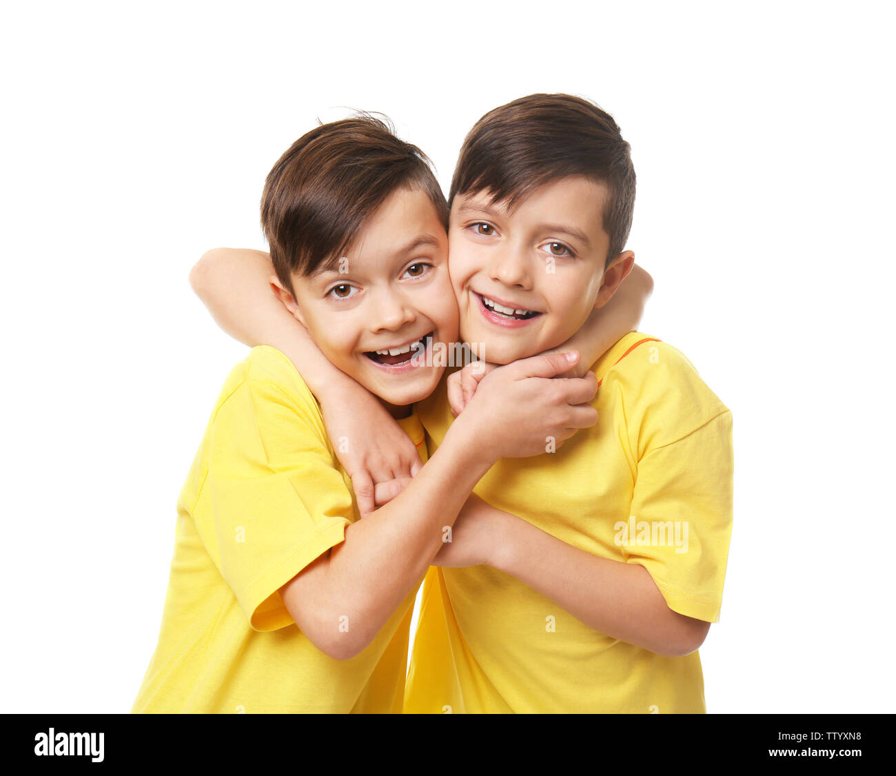 Twin brothers on white background Stock Photo - Alamy