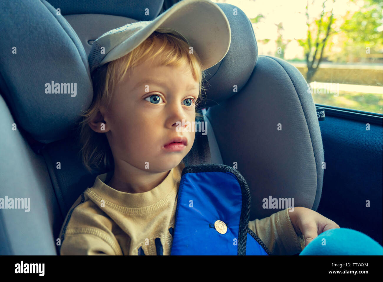 Cute toddler boy sitting in car seat. Child transportation safety Stock ...