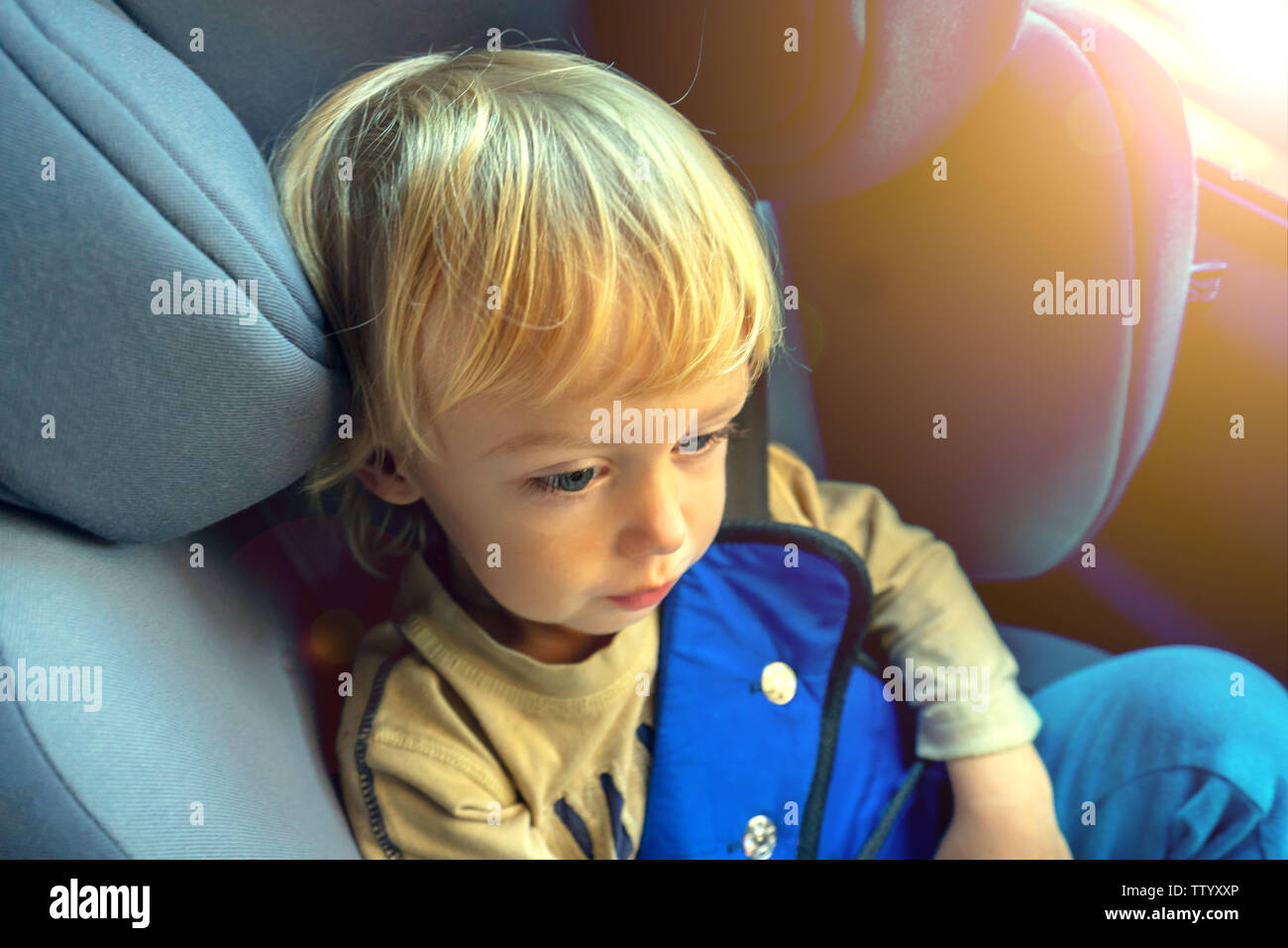 Cute toddler boy sitting in car seat. Child transportation safety Stock ...