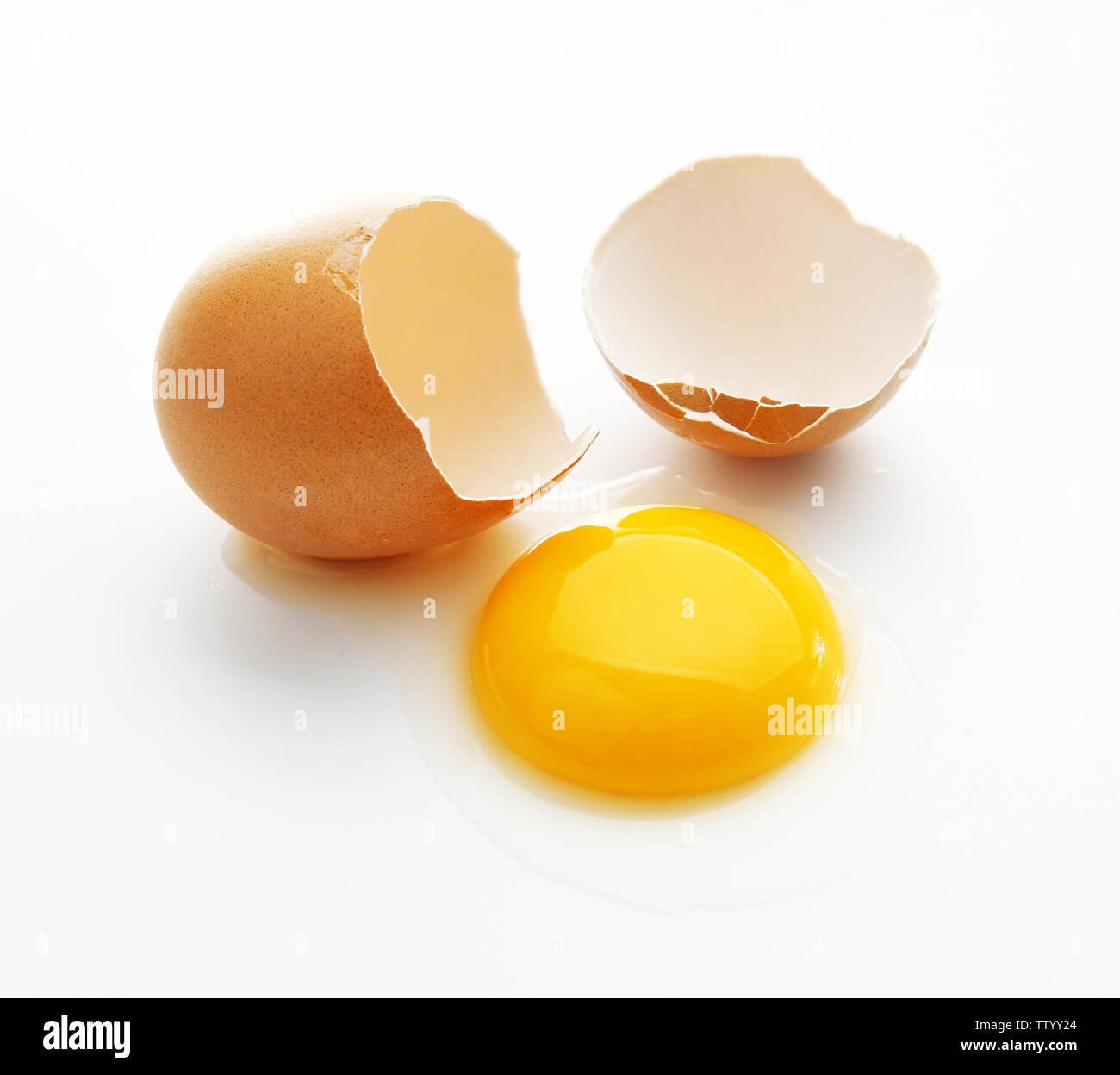 Raw egg yolk on white background Stock Photo - Alamy
