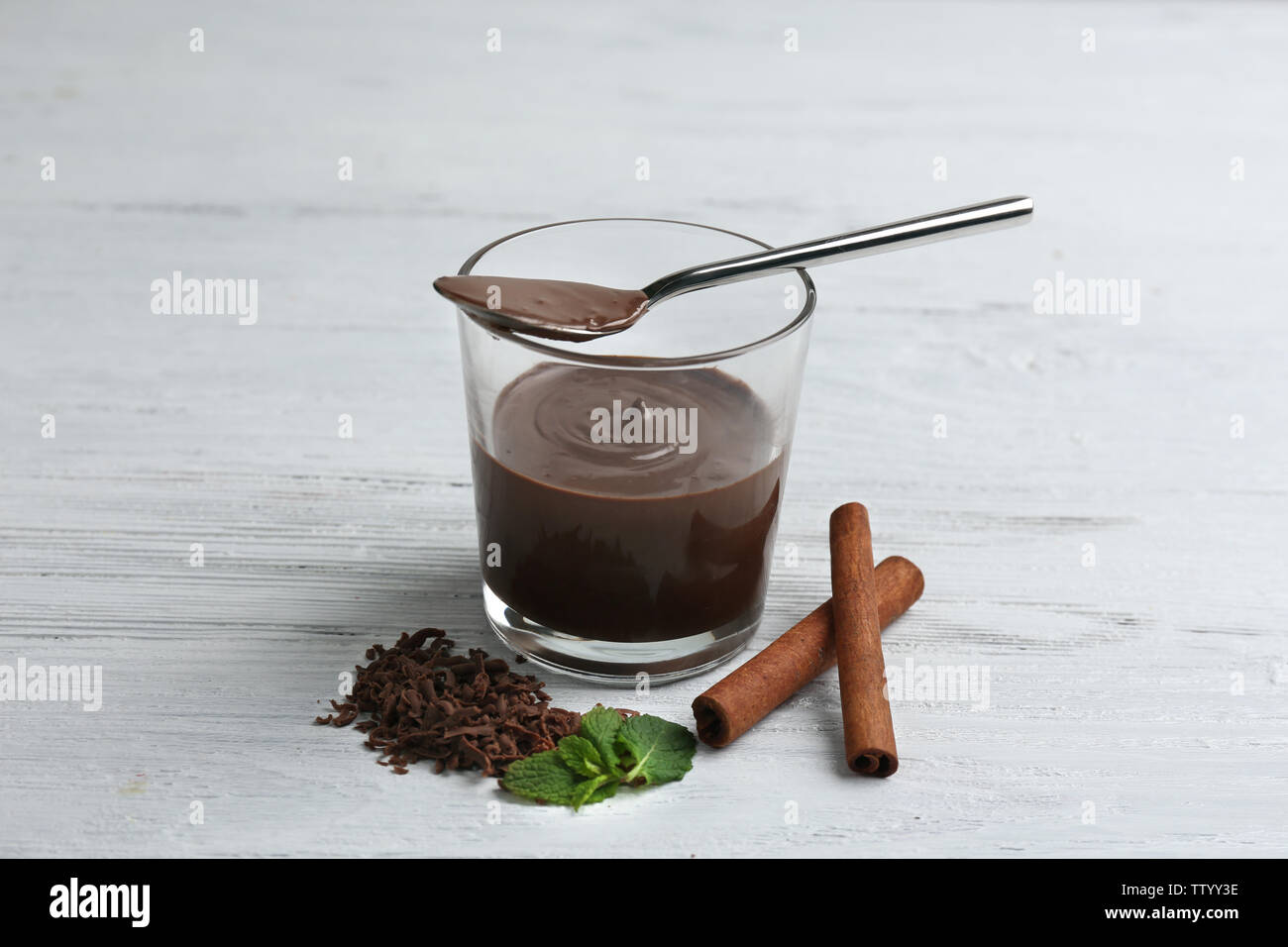 Chocolate mousse in glass with spoon on wooden background Stock Photo ...